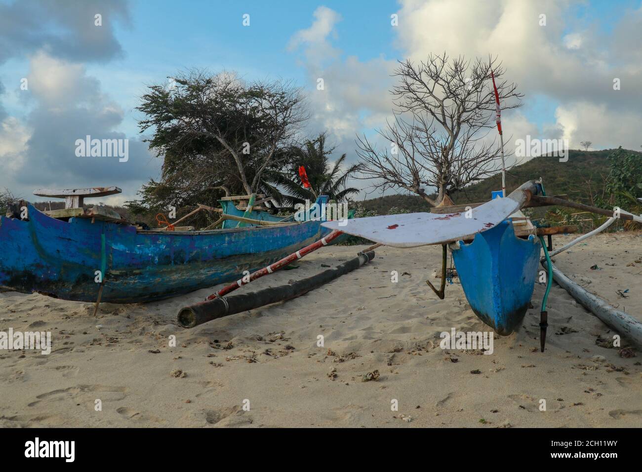 Traditional boat perahu. Wooden fishing boat on a sandy beach Mawun ...