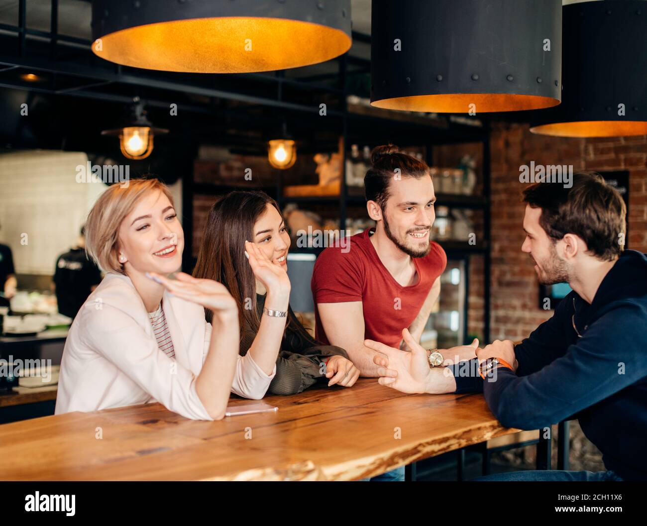Group of four friends discussing their future plans together. Two women ...