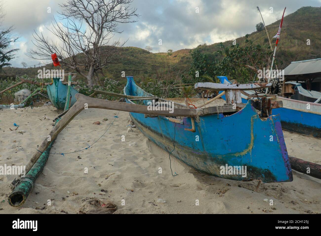 Traditional boat perahu. Wooden fishing boat on a sandy beach Mawun ...