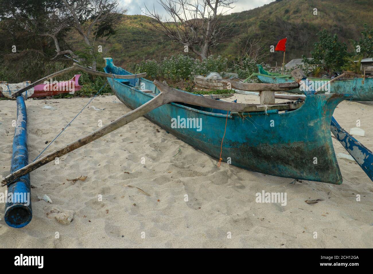 Traditional boat perahu. Wooden fishing boat on a sandy beach Mawun ...