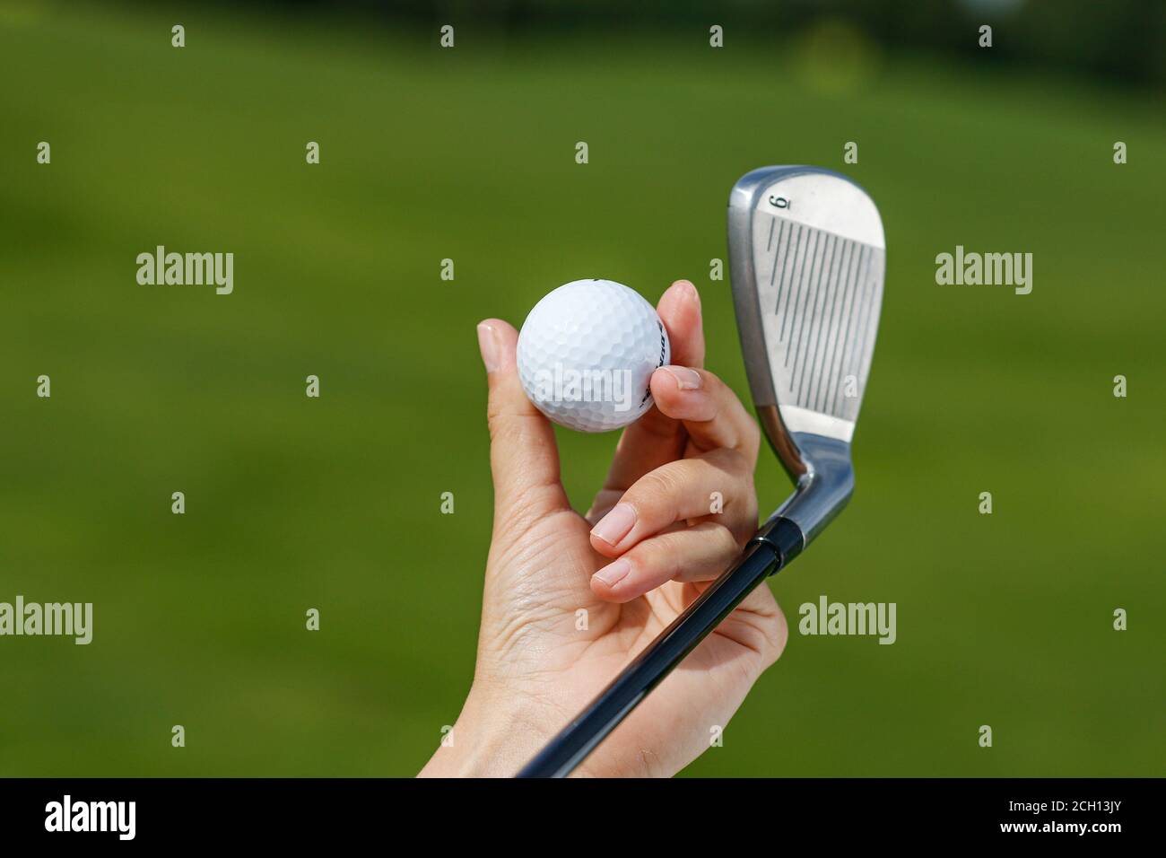Golf ball in golfer's hand Stock Photo - Alamy