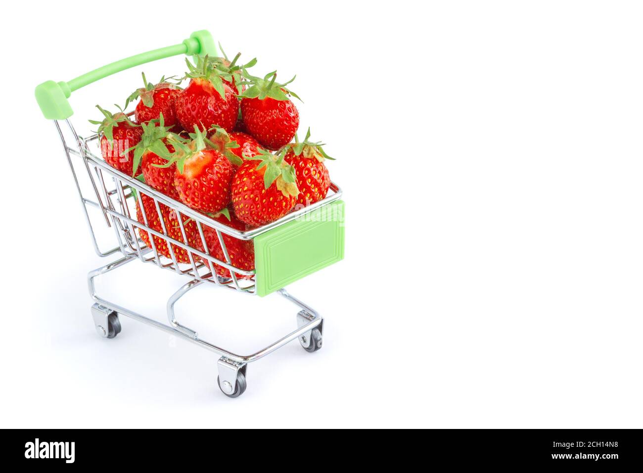 Grocery cart with strawberries on a white background. Strawberries in a ...
