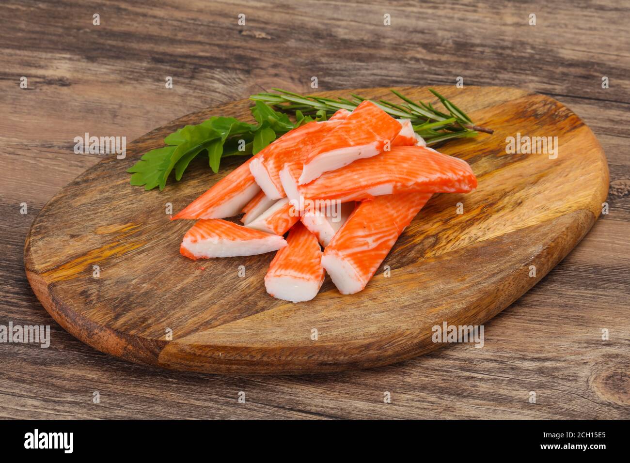 Crab stick surimi over wooden board Stock Photo - Alamy