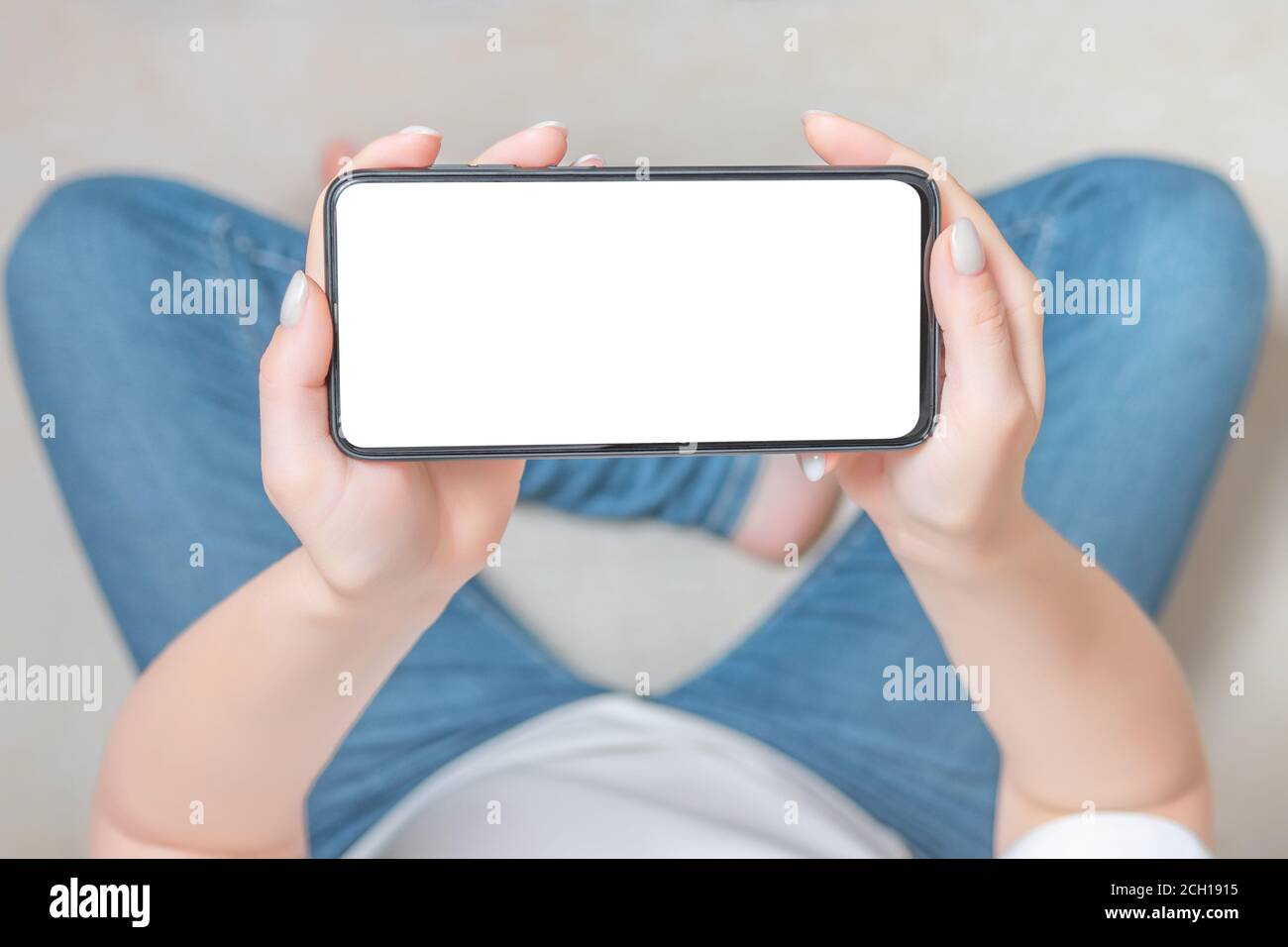 Mockup image blank white screen cell phone. female hands holding ...