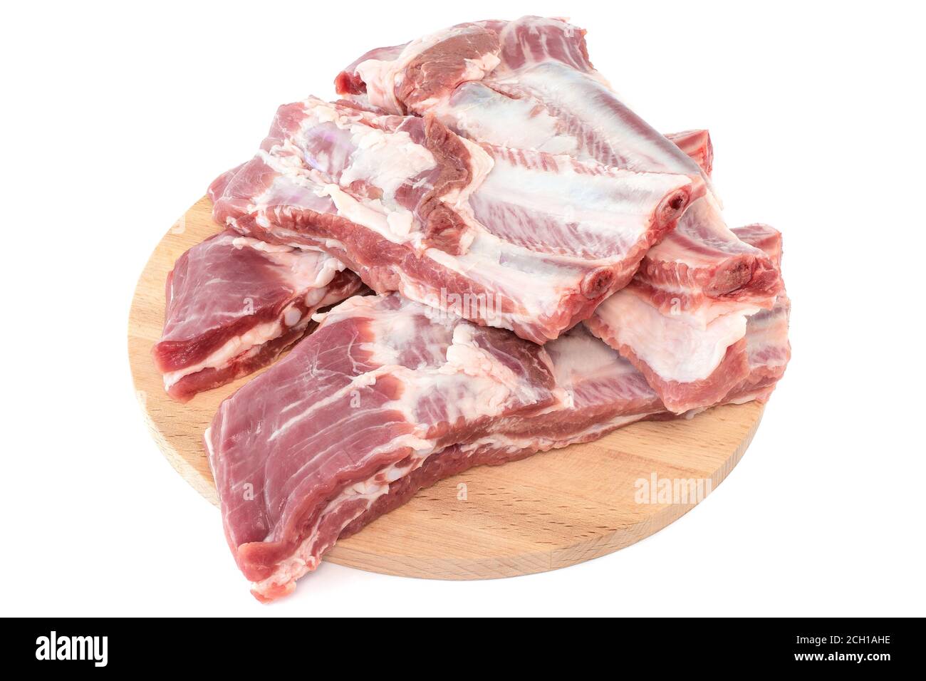 Raw pork ribs laid out on a wooden cutting board. Whole raw pork ribs ...