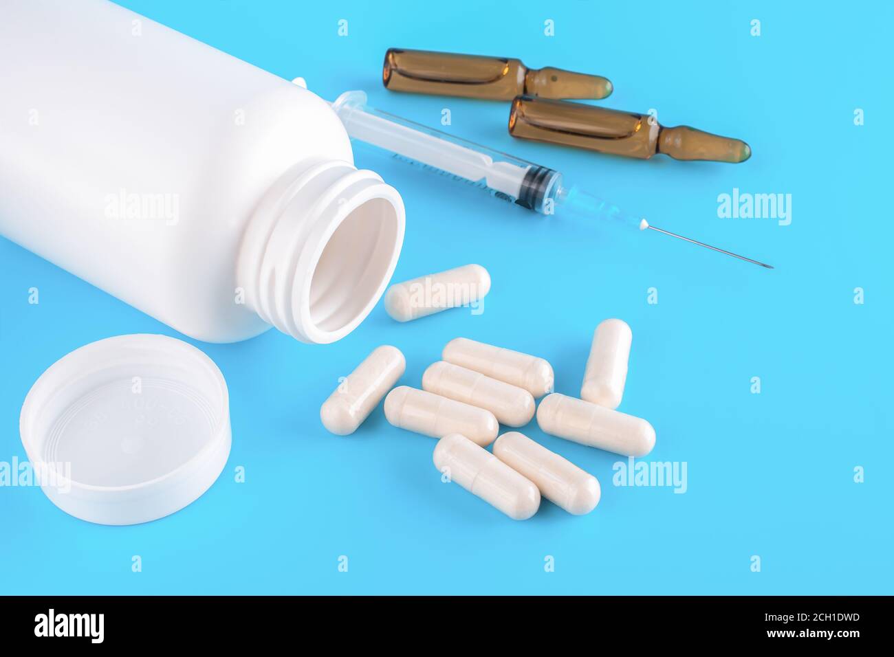 Pills, Syringe, ampoules for injections on a blue medical background ...