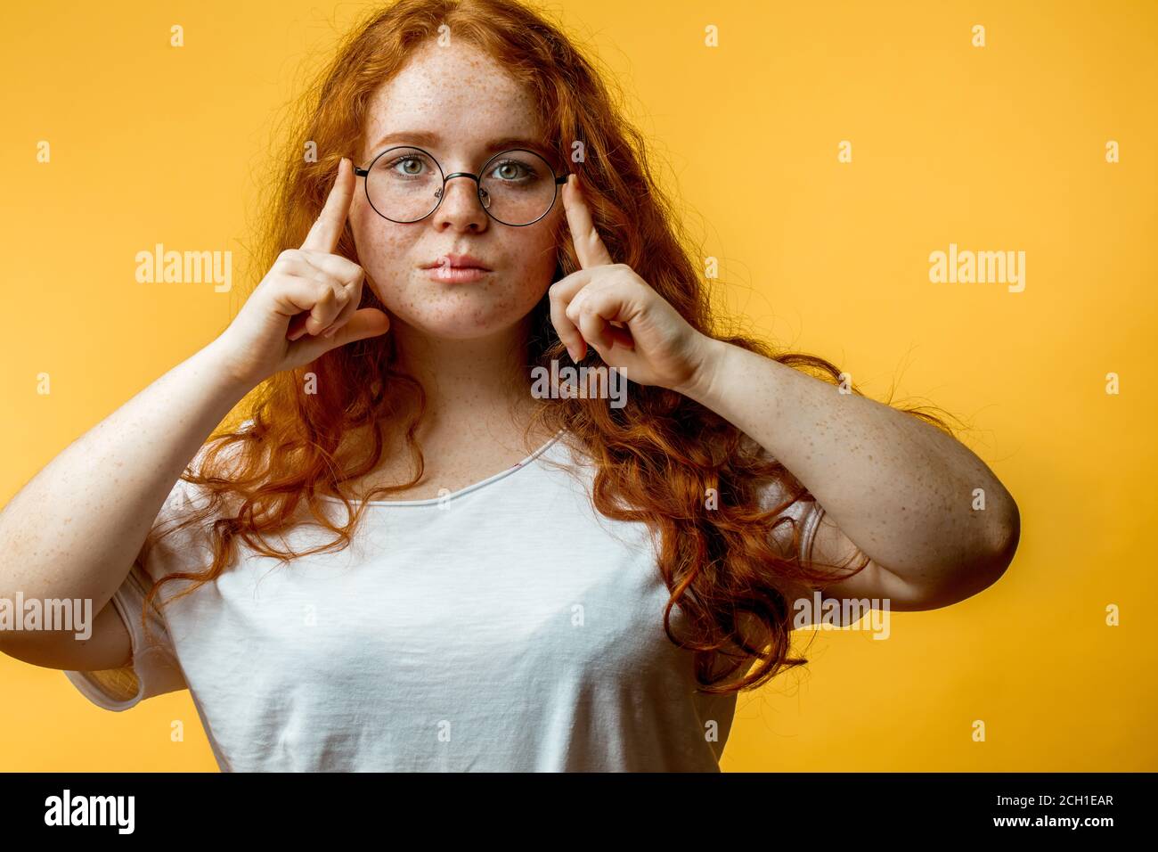 Young woman temples finger hi-res stock photography and images - Alamy