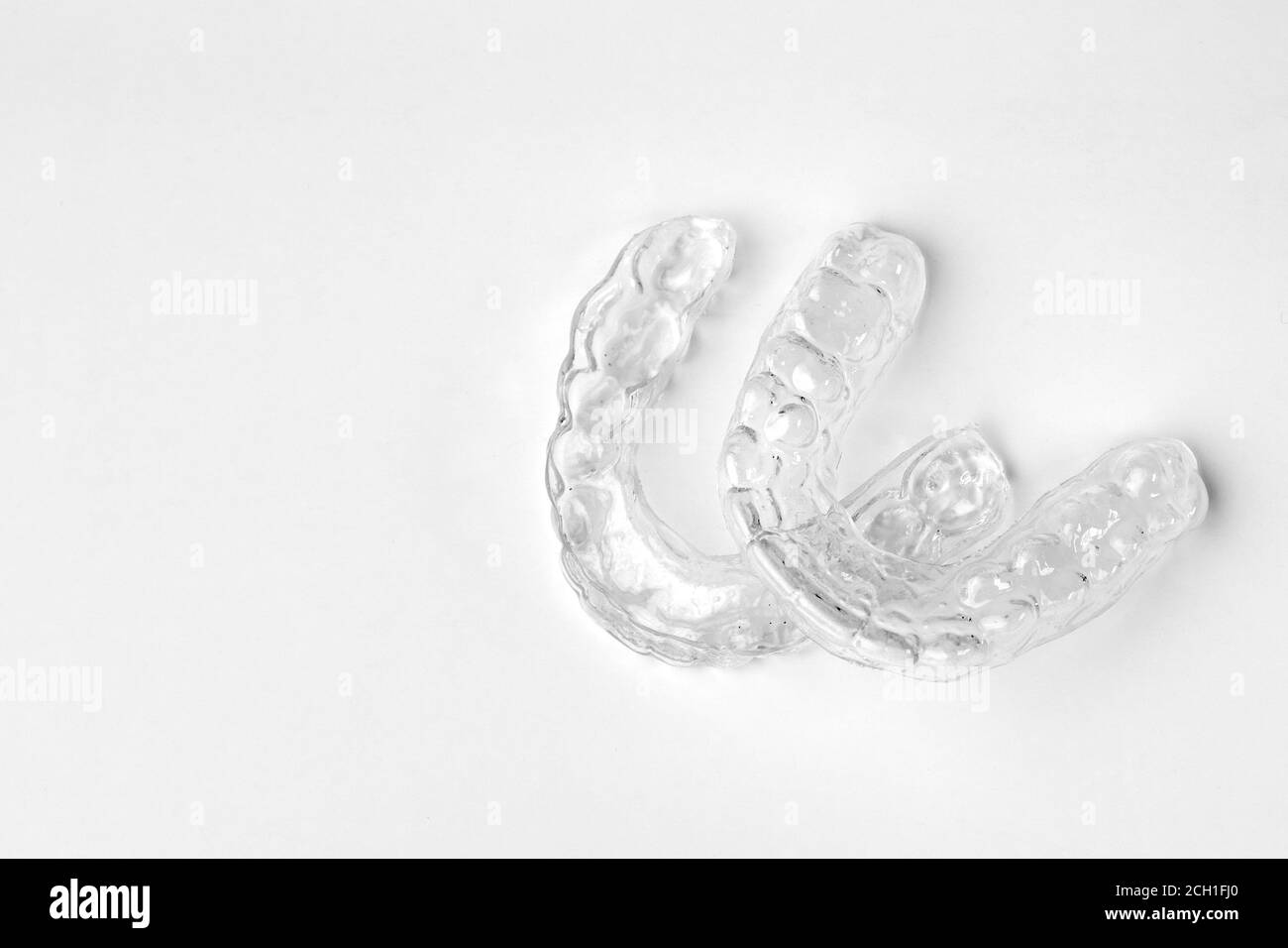 Invisible orthodontic removable braces on a white background with copy ...