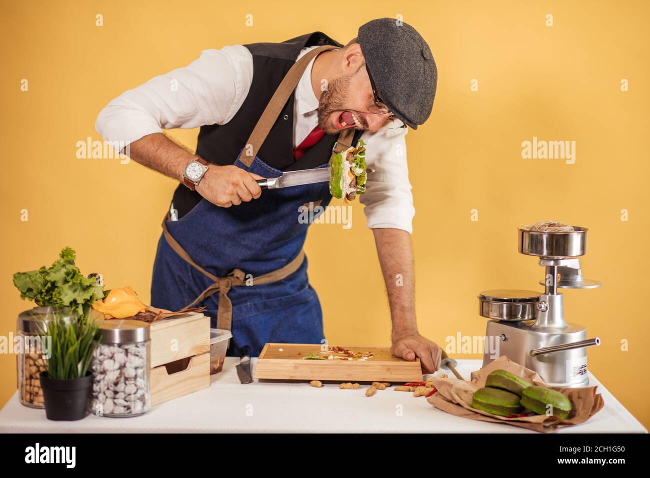 Hungry man is going to swallow half of appetising beef burger, he just ...