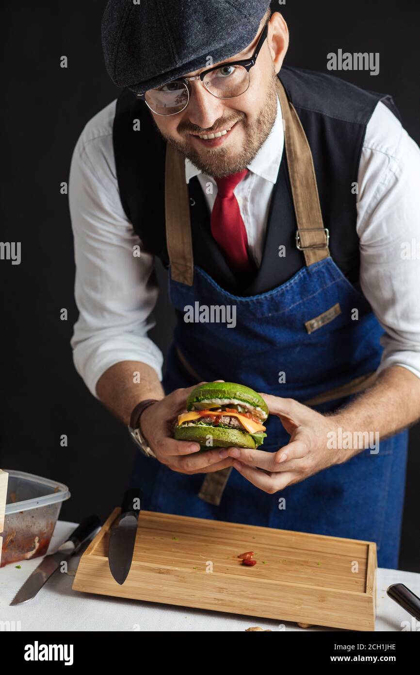 Master Chef shows freshly made tasty burger with meat patty and green ...