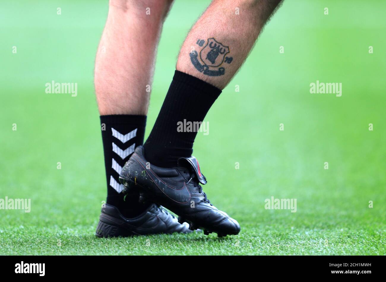 A member of staff with an Everton tattoo on his leg during the Premier ...