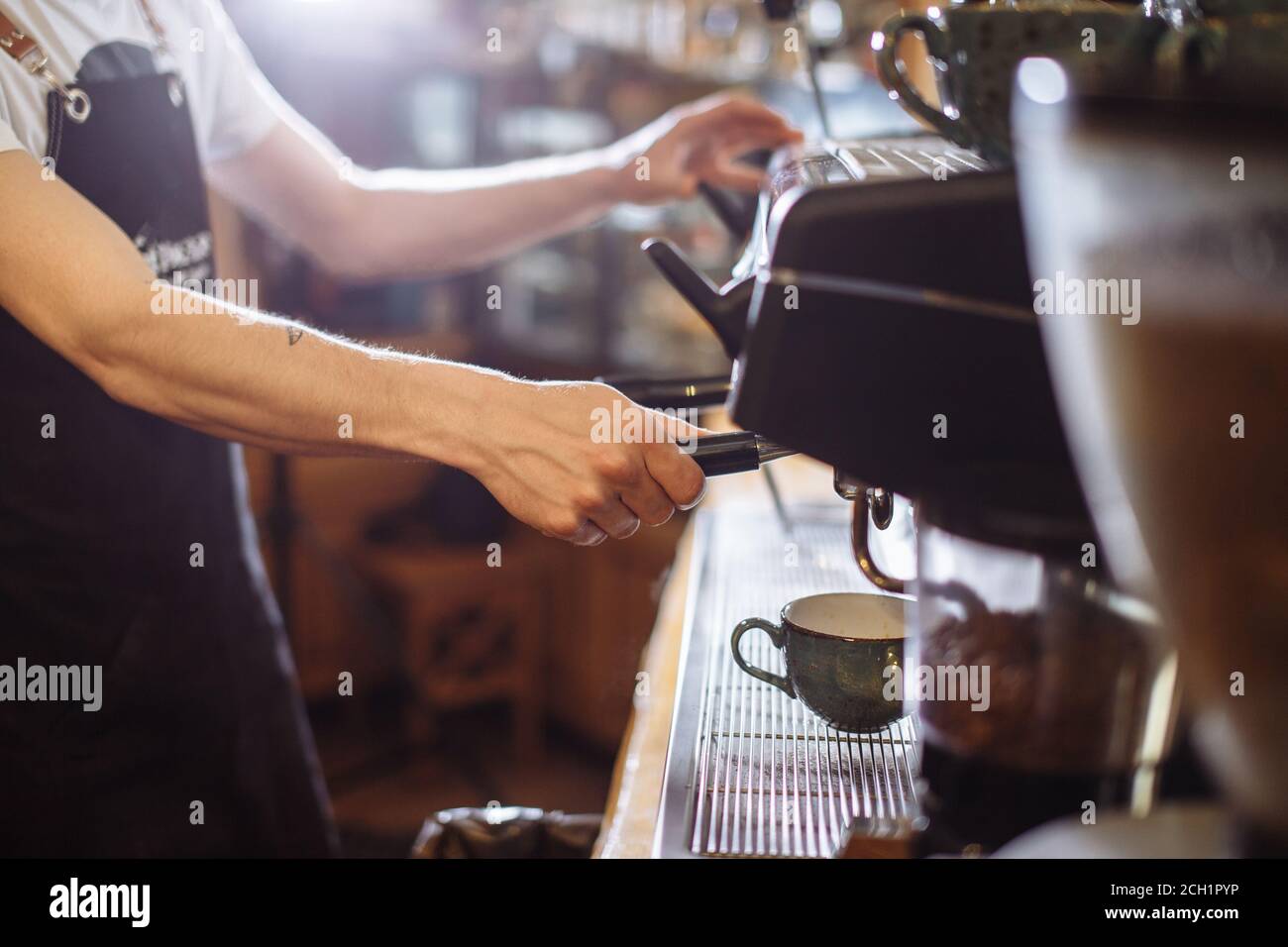 barista is preparing and serving different types of coffee in the bar ...