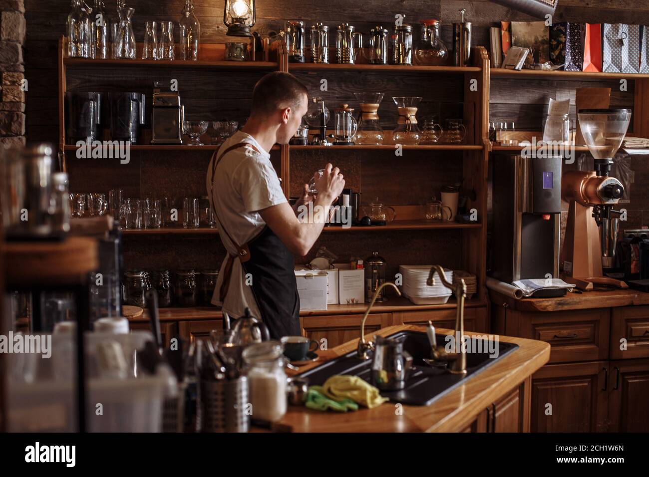 a young barista is cleaning in the coffee shop Stock Photo - Alamy