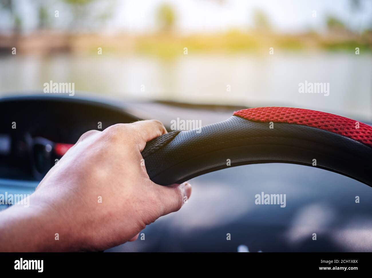 Driving concept, Hand driving a car on the road Stock Photo - Alamy