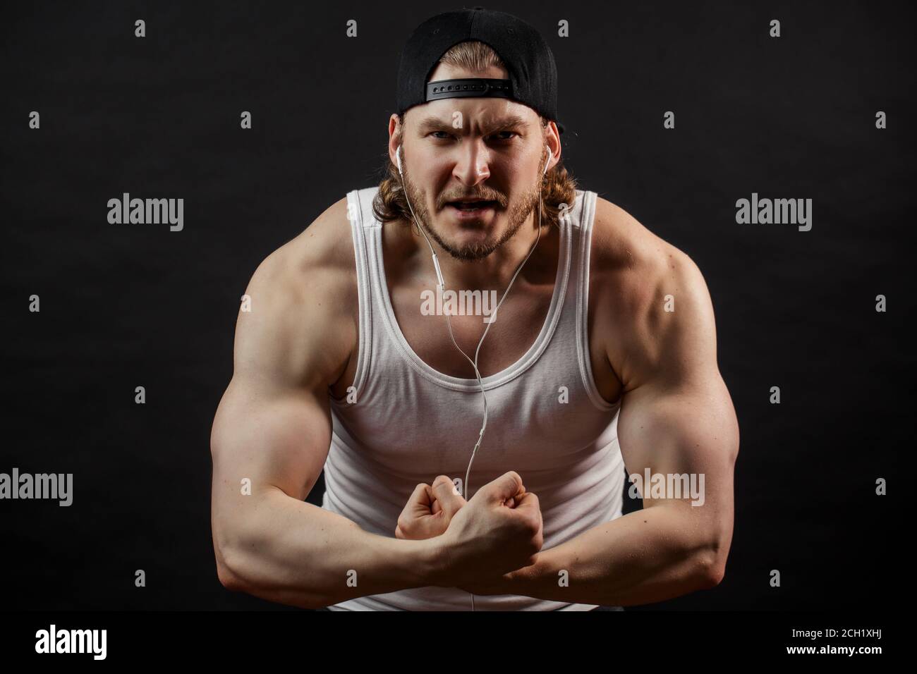 muscles of iron. guy is developing his muscles in the workshop Stock ...