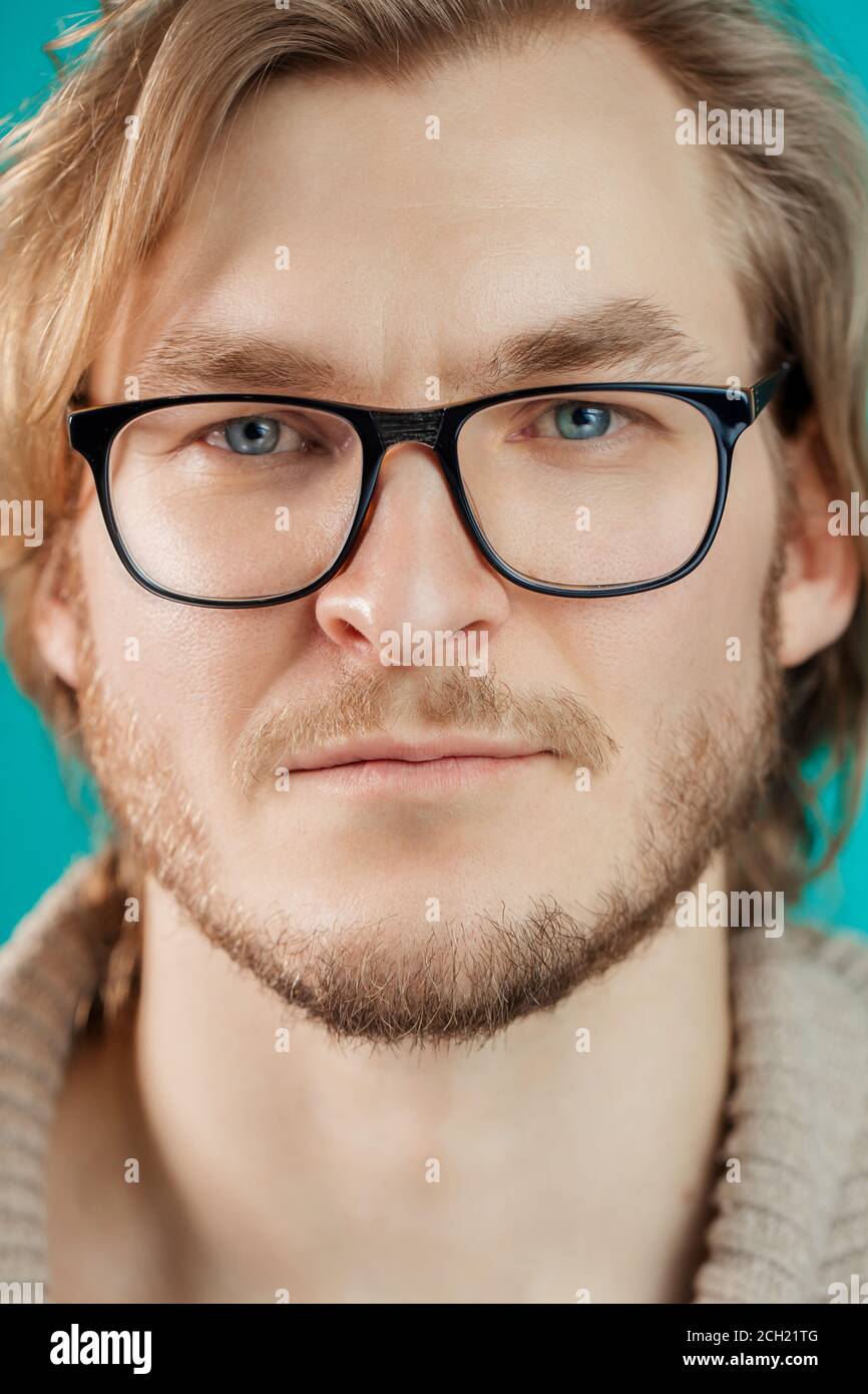 closeup portrait of handsome male with fair hair and beautiful blue ...
