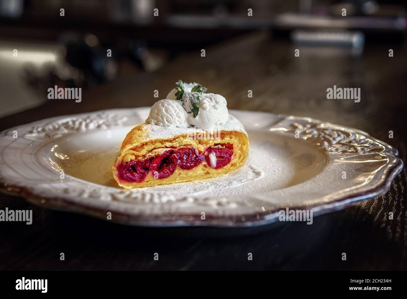Cherry strudel with white dishes close-up. piece of strudel is lying on ...