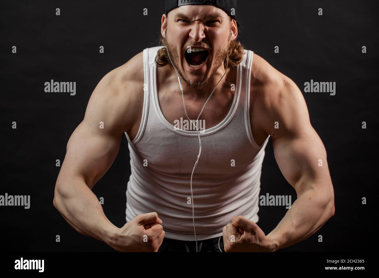 angry man with open mouth is tensing his muscles Stock Photo - Alamy