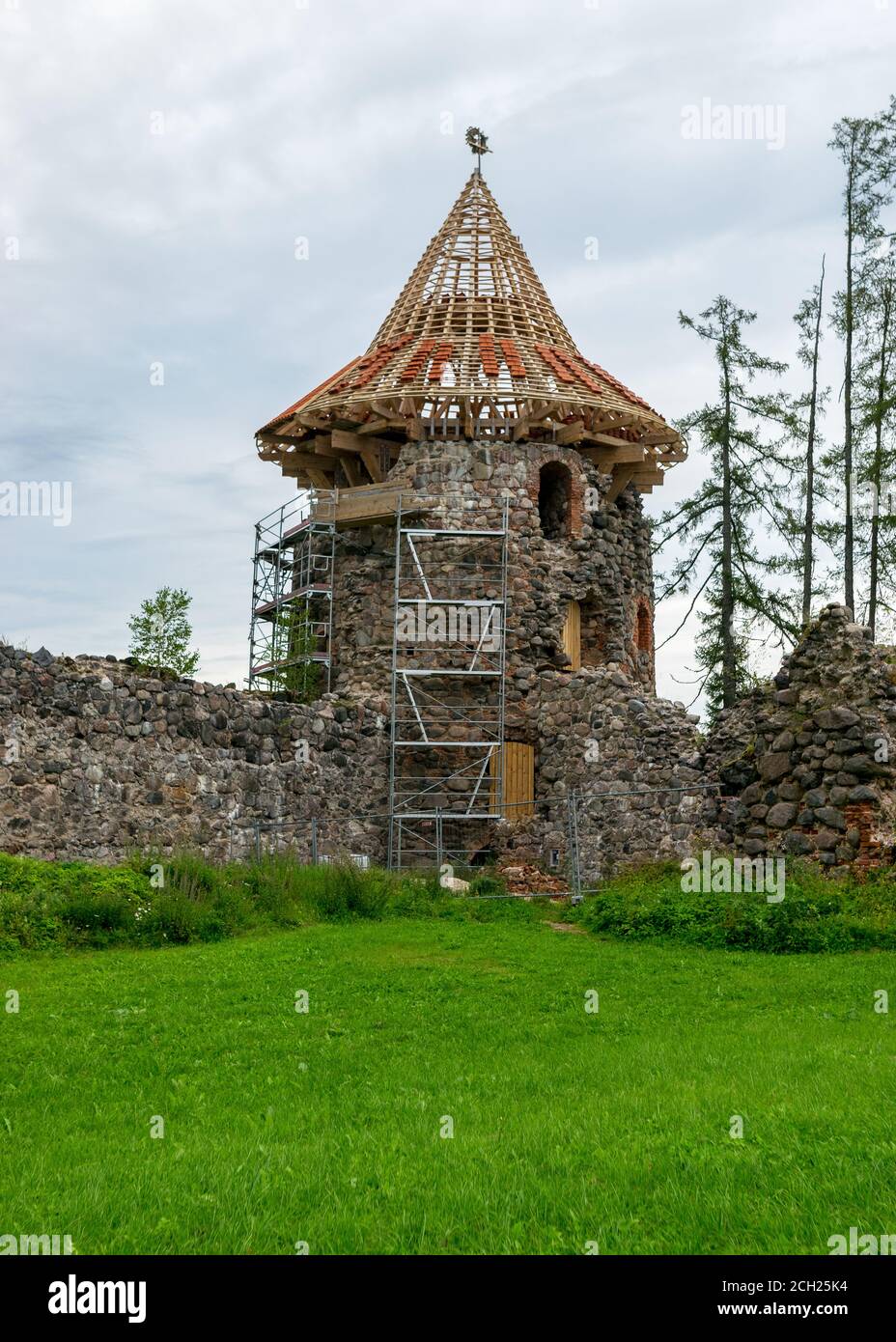 old medieval stone castle ruins, castle tower with new roof structure ...