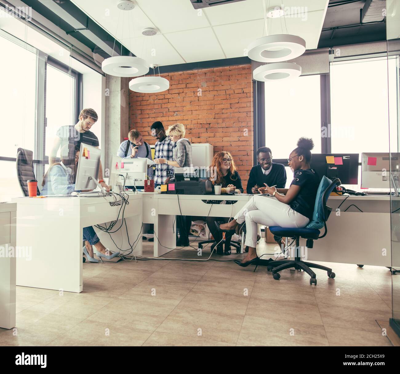 busy office interior with loft style.working people in authentic ...