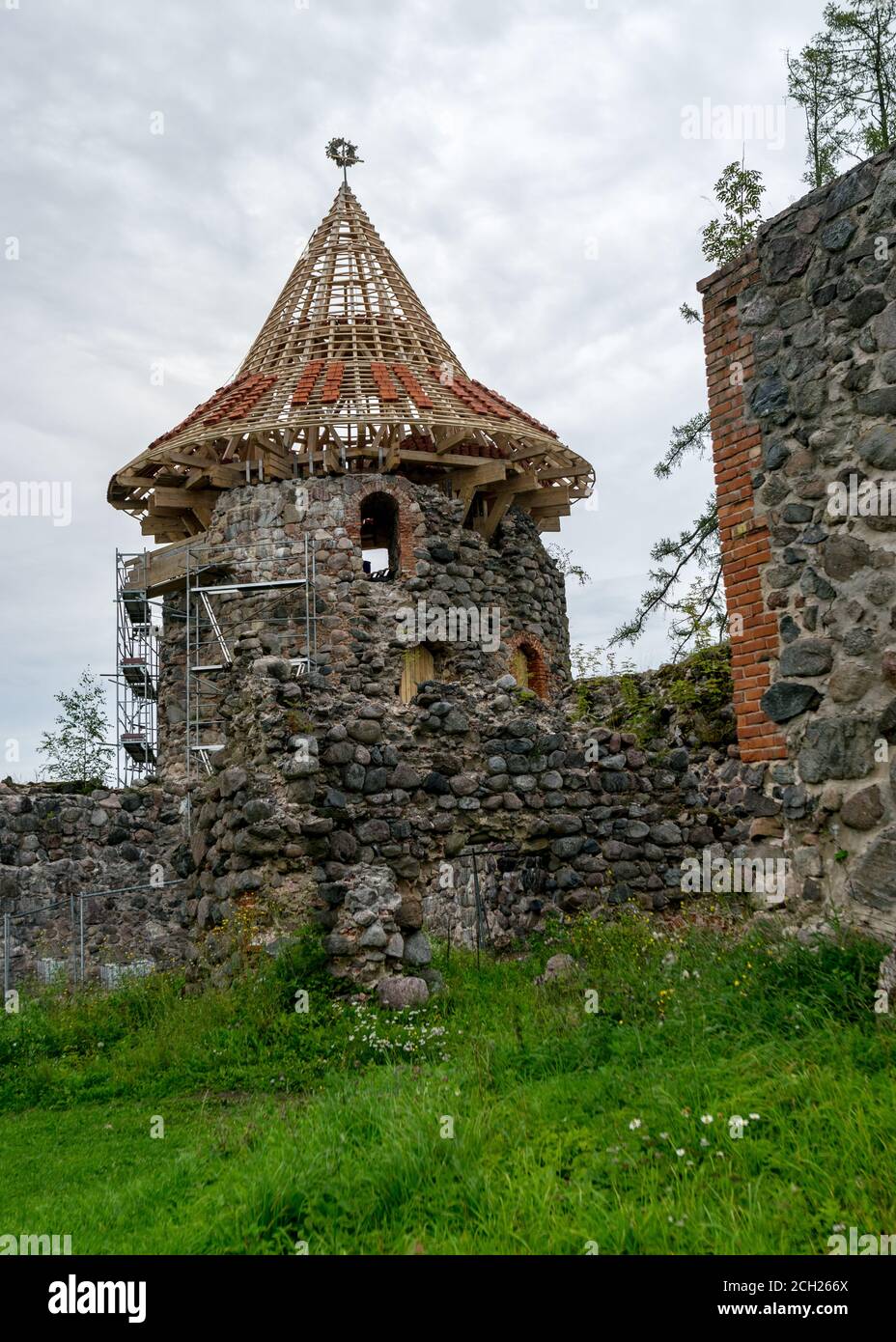 old medieval stone castle ruins, castle tower with new roof structure ...