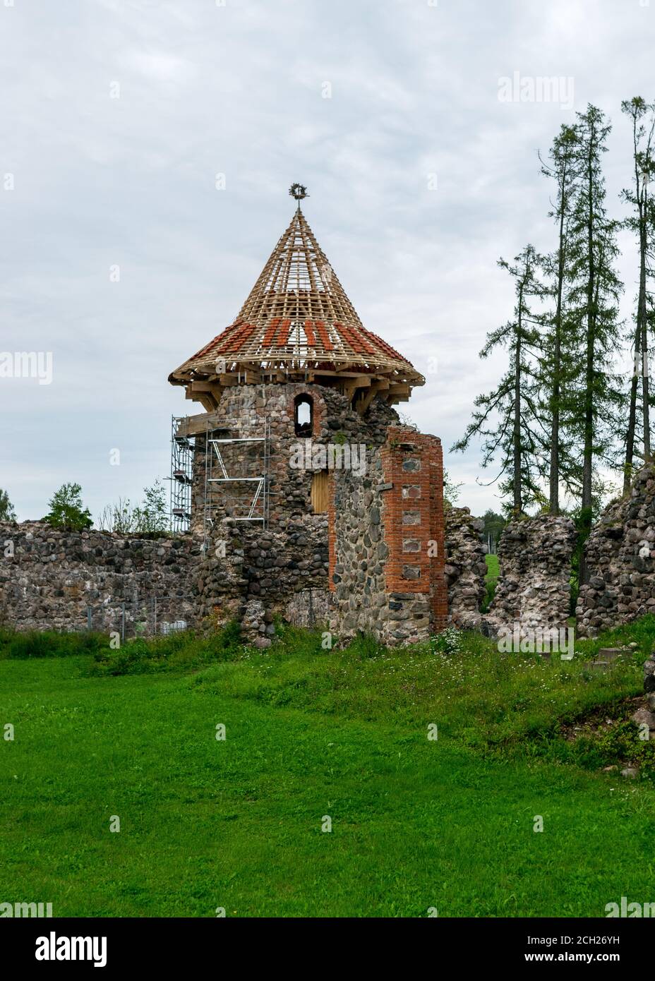 old medieval stone castle ruins, castle tower with new roof structure ...