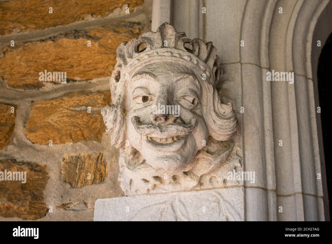 A Detailed Statue of a Creepy Face on a Cobblestone Wall at the Elkins ...