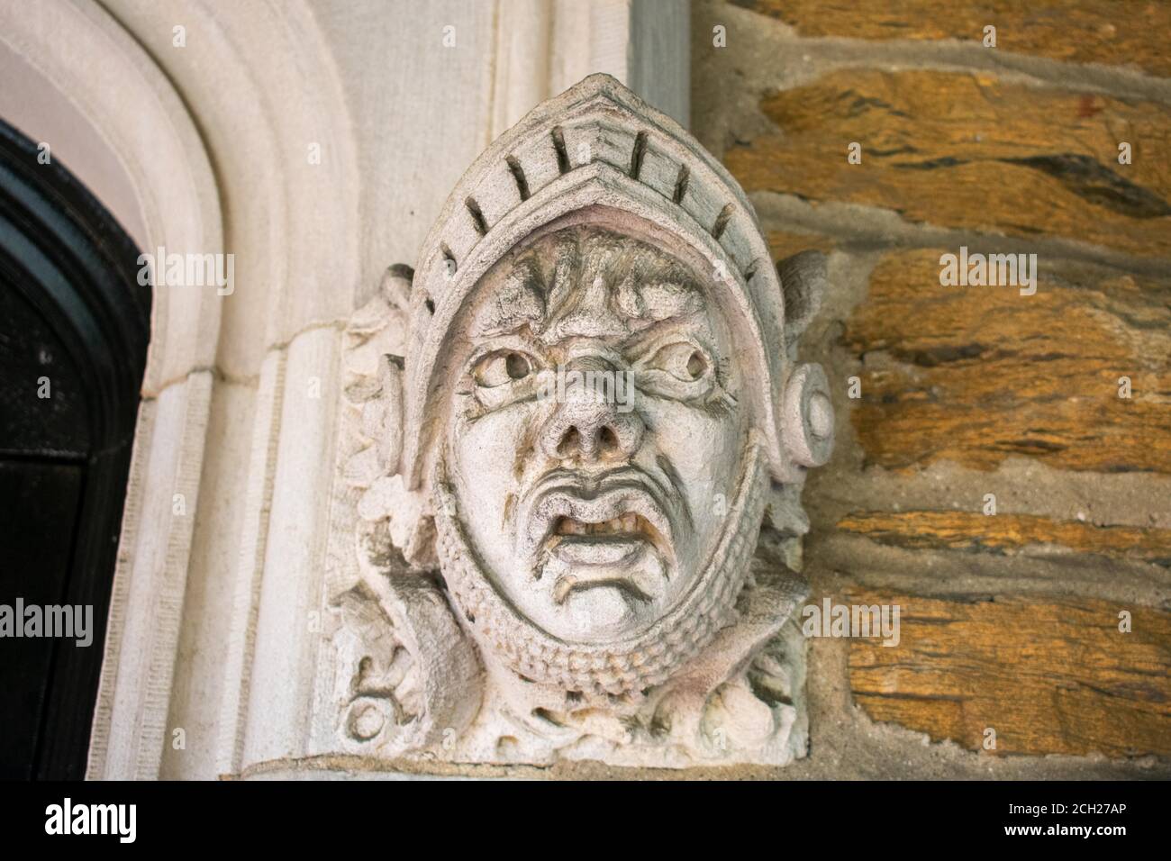 A Detailed Statue of a Creepy Face on a Cobblestone Wall at the Elkins ...