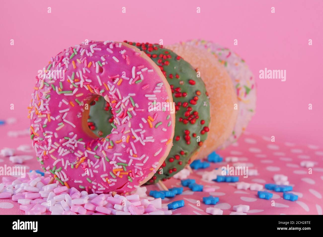 Sweet donuts. Four nicely decorated, tasty looking various color donuts ...