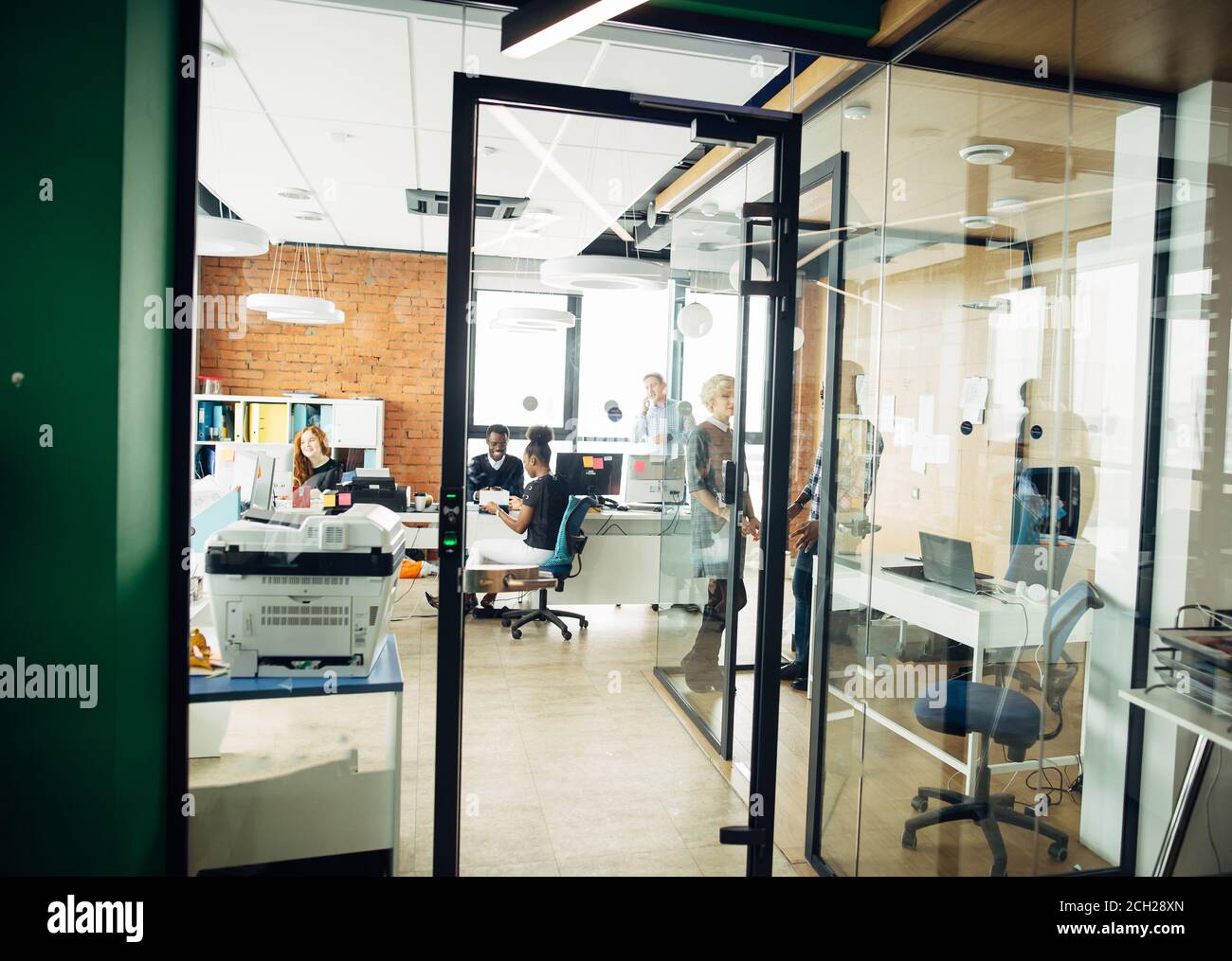 moden glass crowded office in loft style with glass door Stock Photo ...