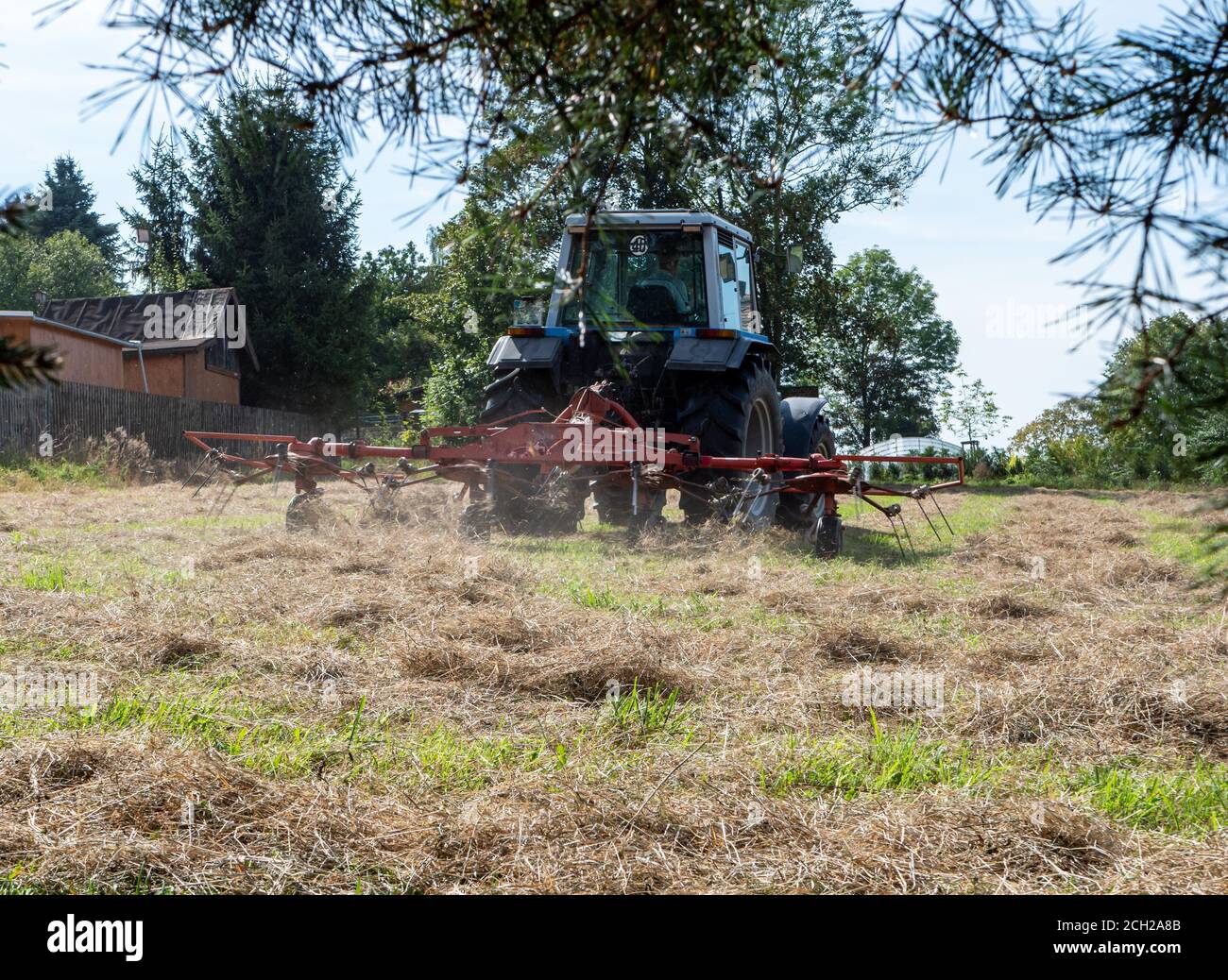 Turning hay with old tractor hi-res stock photography and images - Alamy