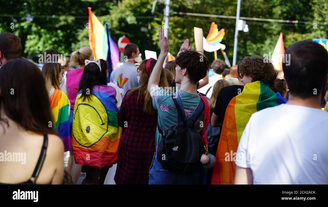 LGBT equality march. Young people wearing rainbow clothes are fighting ...