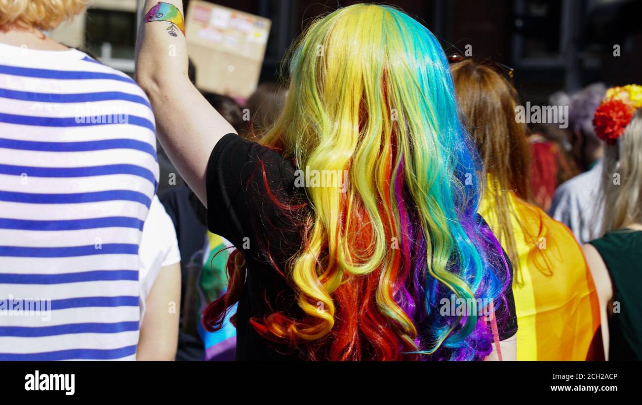 LGBT equality march. Young people wearing rainbow clothes and symbols ...