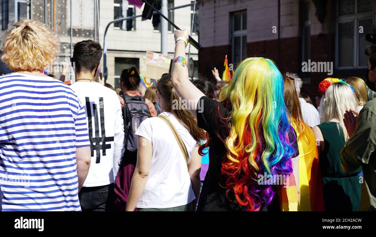 LGBT equality march. Young people wearing rainbow clothes and symbols ...