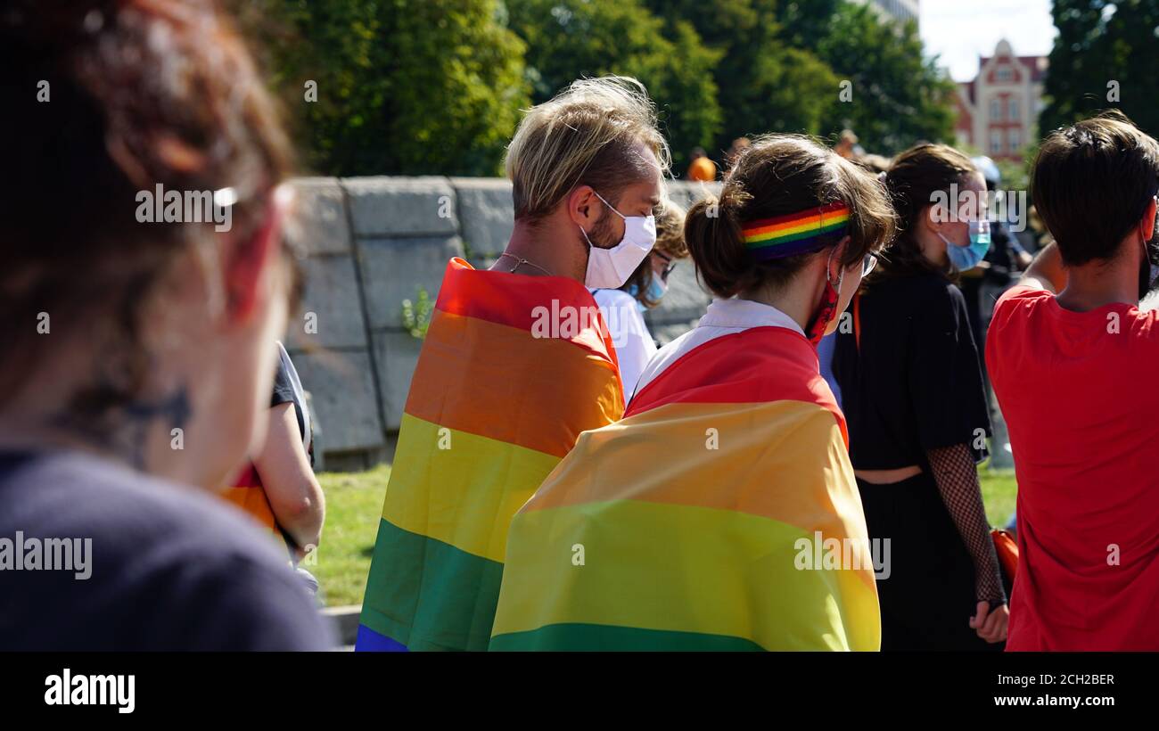 LGBT equality march. Young people wearing rainbow clothes and symbols ...
