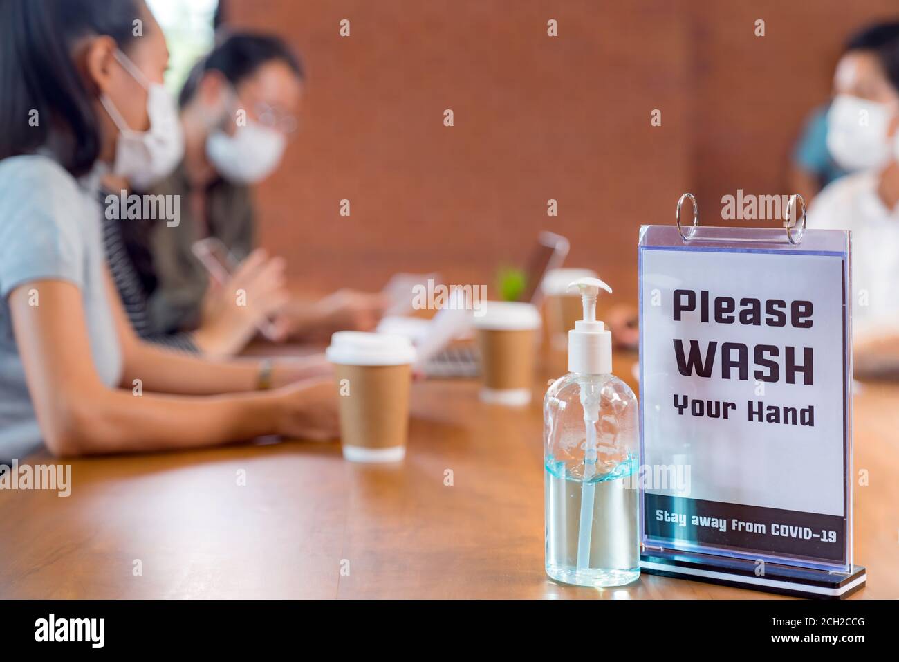 Signage of Hand sanitizer alcohol gel in meeting room with background ...