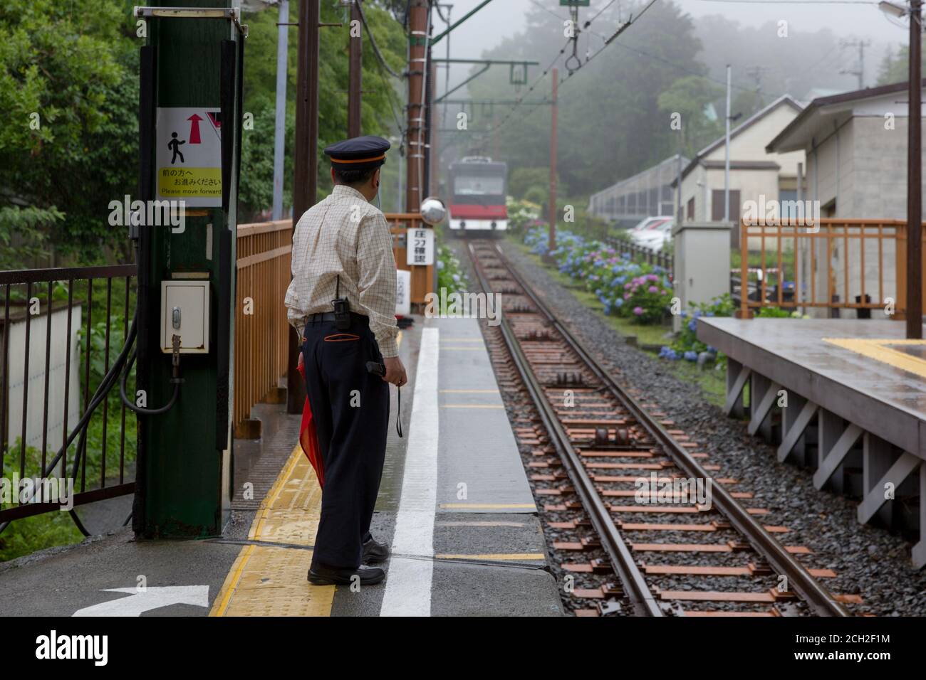 Hakone / Japan - June 19, 2018: Conductor waiting for the Hakone Tozan ...