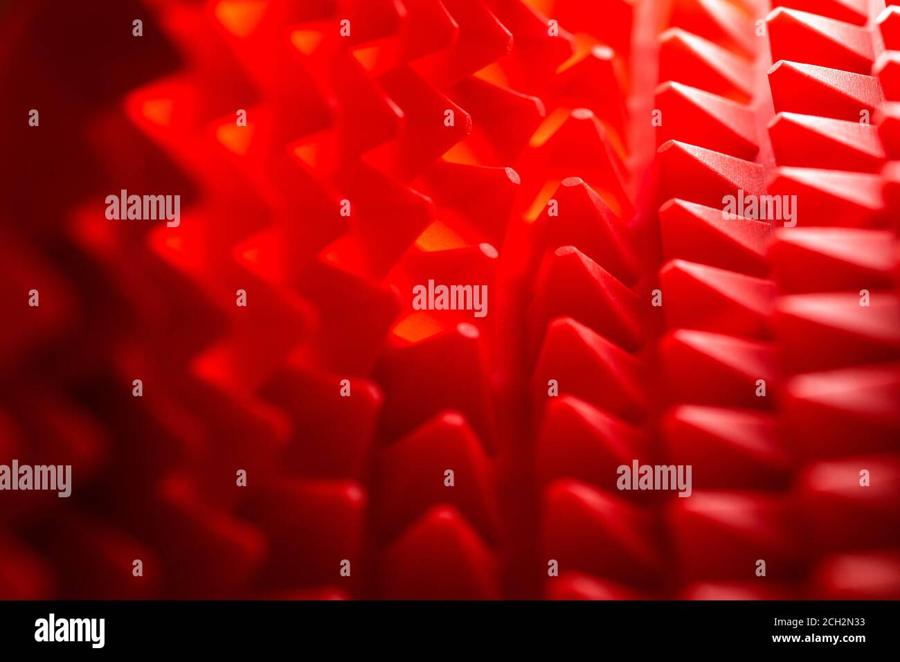abstract red silicone pyramids mat close-up background with selective ...