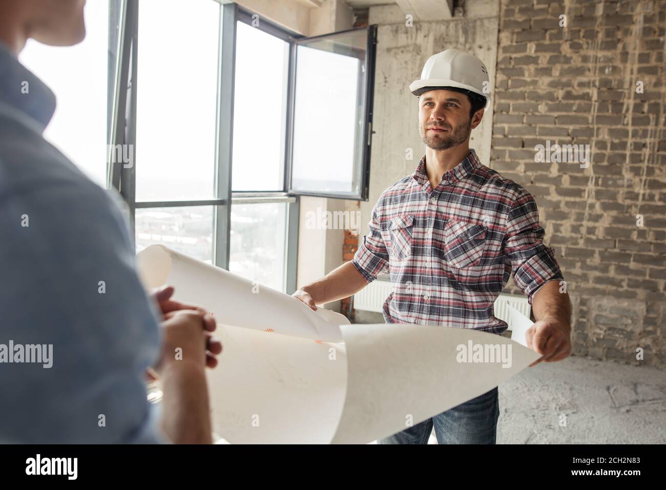 good looking engineer with blue eyes is listening to the chief's ...