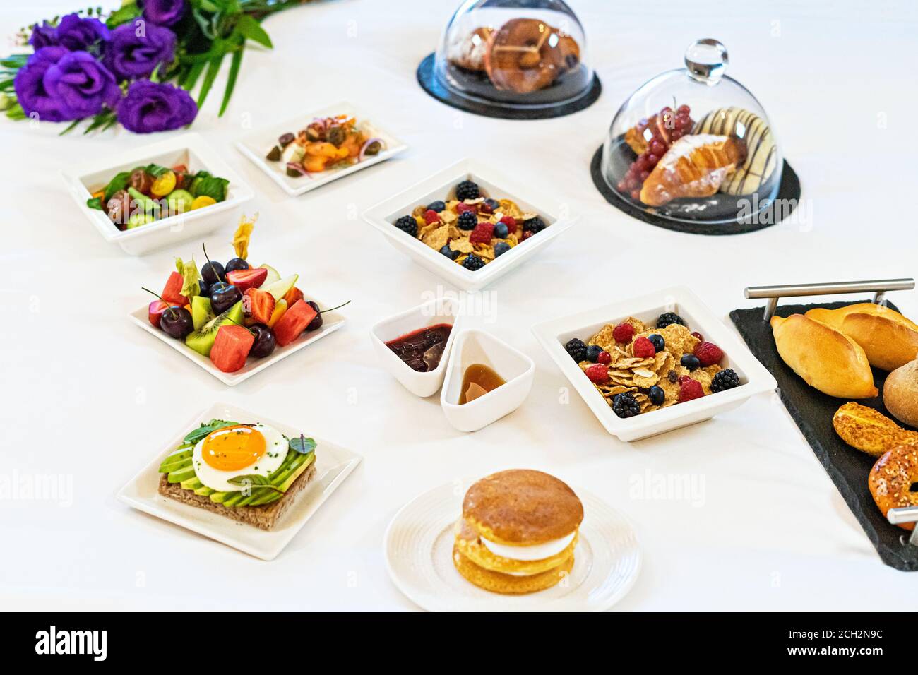 Tray plates with assorted breakfast meal on a bed in a hotel room Stock ...