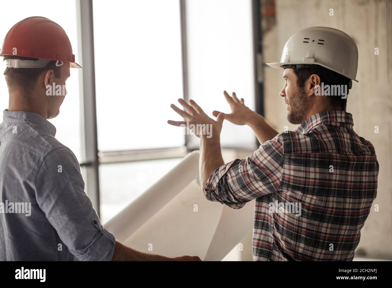 talented engineer with raised arms showing a project to a boss. back ...
