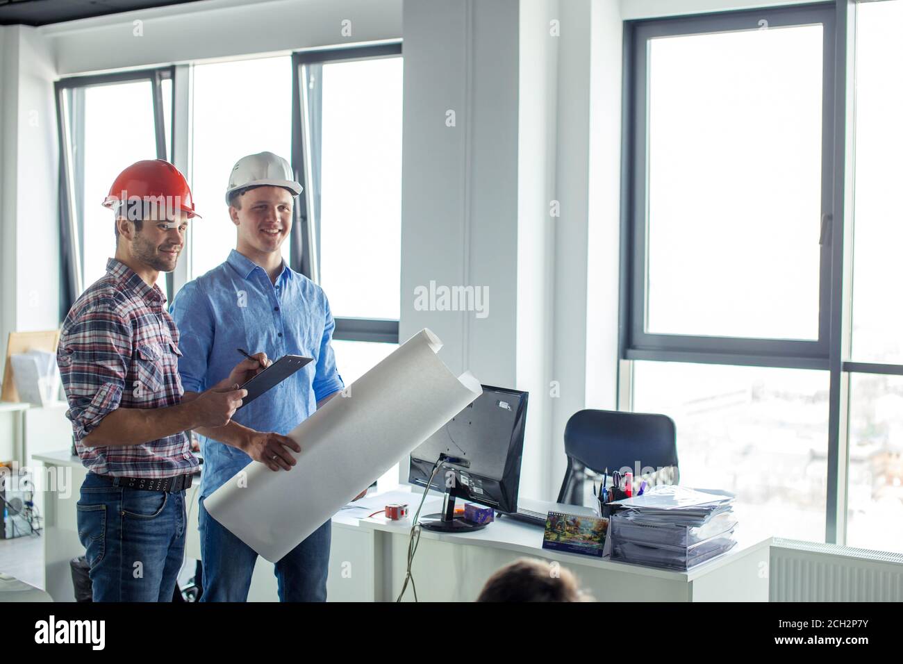 a boss with a manager are controling the office work. side view photo ...