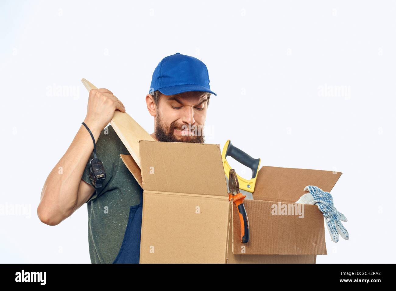Worker man in uniform with a box in his hands tools delivery service ...