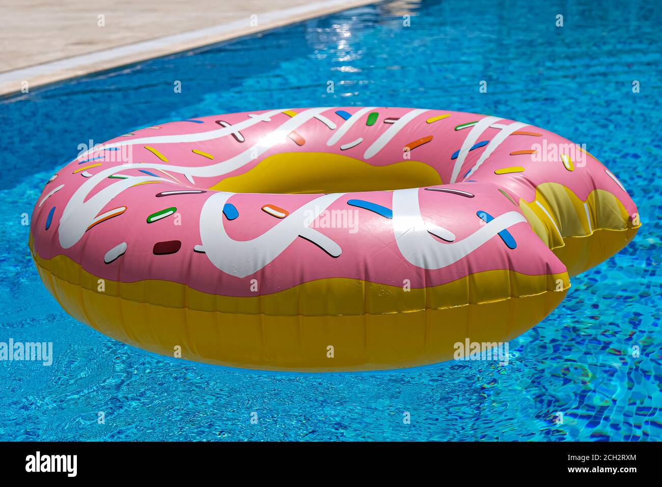 pink inflatable donut doughnut floating mattress in swimming pool ...
