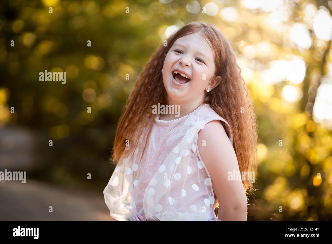 Adorable, ginger little girl smiles and shows missing front teeth Stock ...