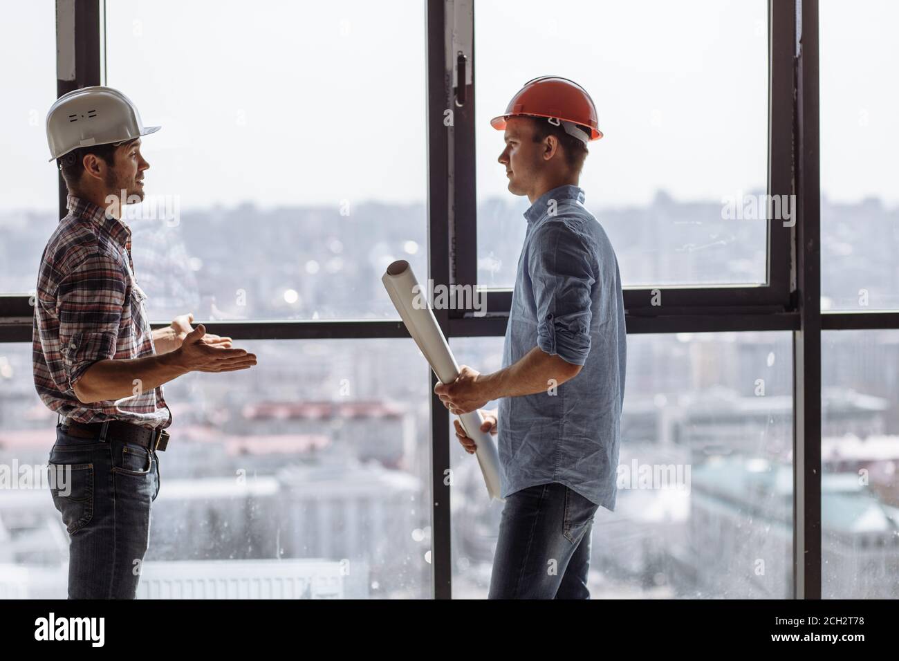 two active ambitious engineers are talking about building model of a ...