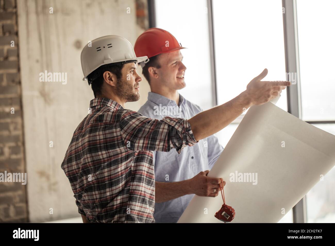 positive worker is showing the the progress of construction to a leader ...