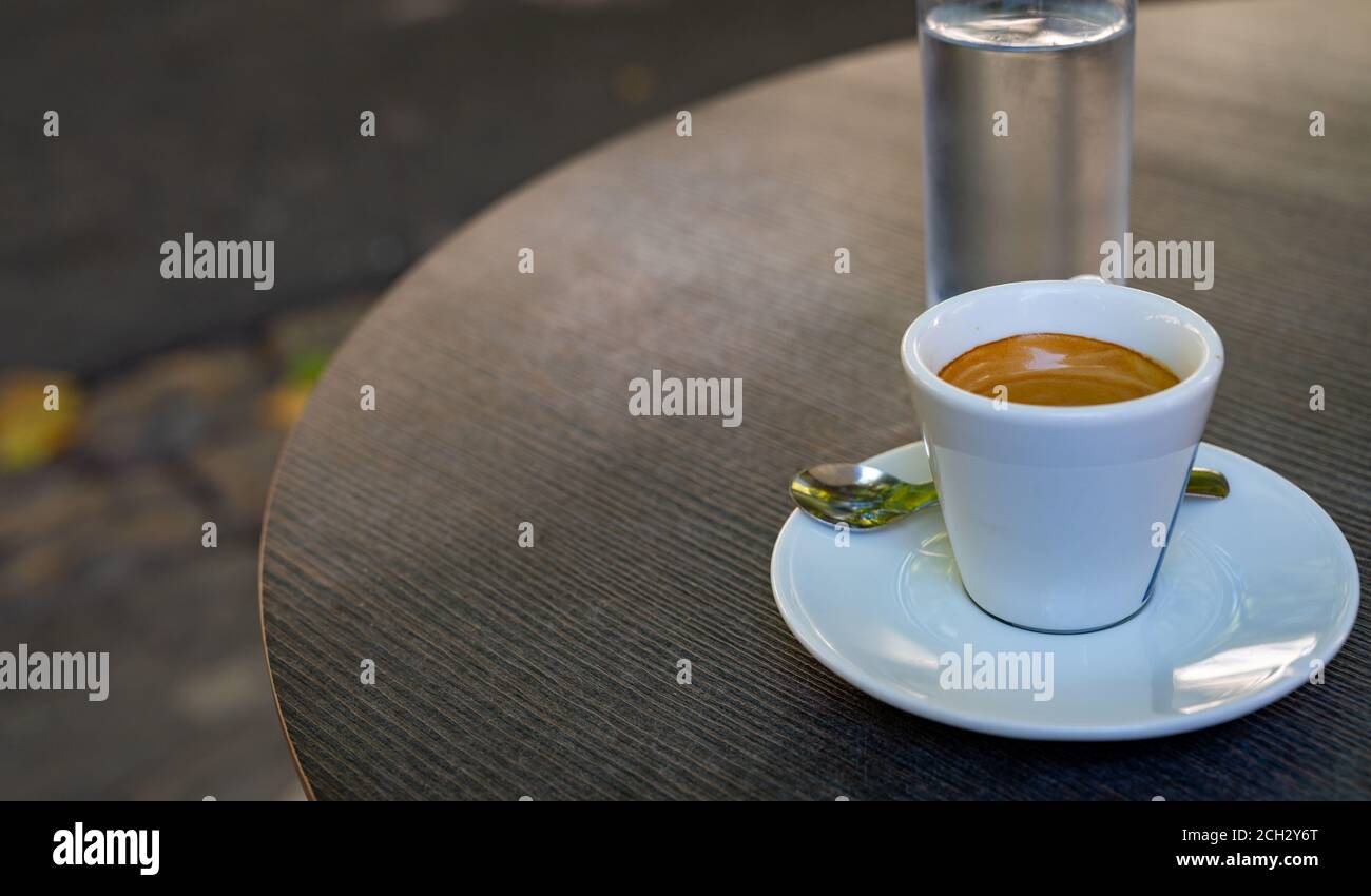 Drinking of strong black espresso coffee on outdoor terrace in cafe ...