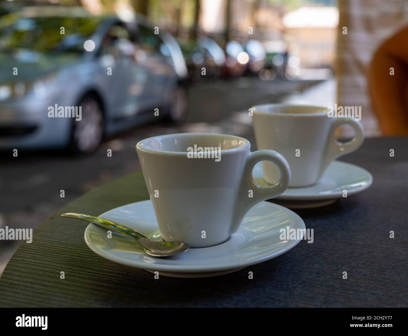 Drinking of strong black espresso coffee on outdoor terrace in cafe ...