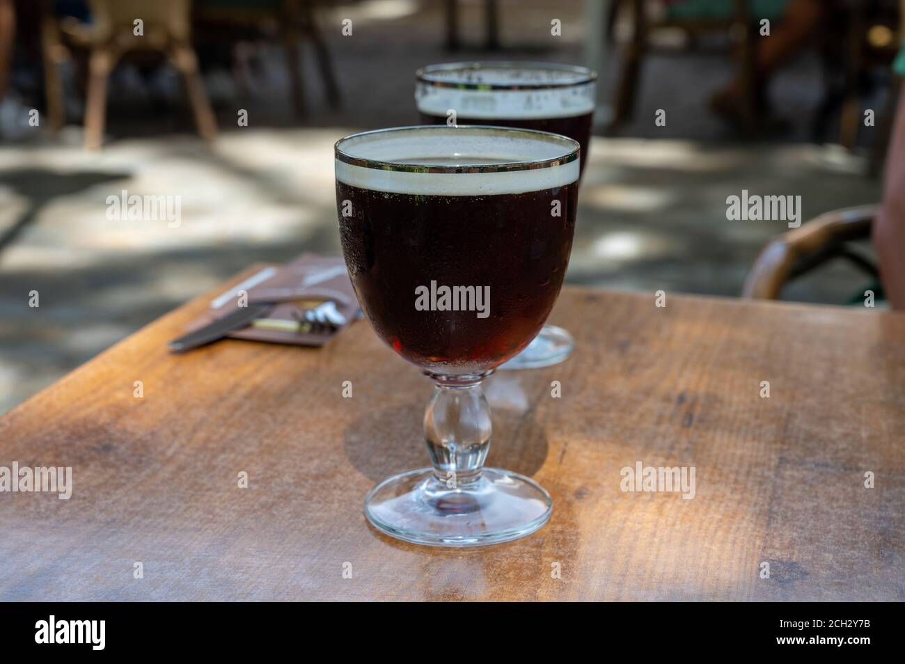 Glasses with cold dark strong Belgian abbey beer served outdoor Stock ...